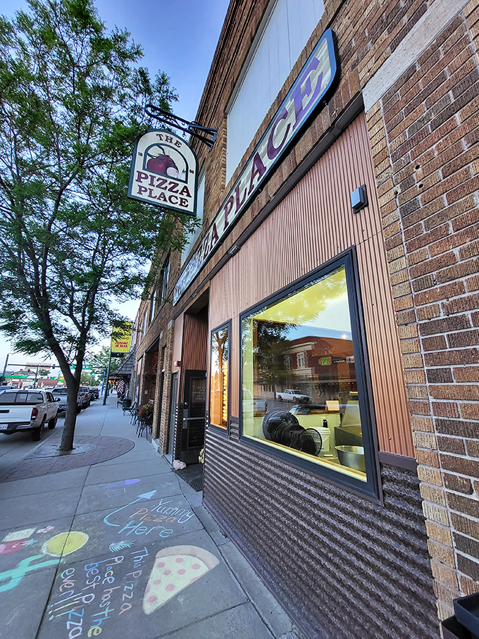 Main Street magic in a classic brick storefront! The neon "OPEN" sign beckons pizza lovers like a lighthouse for hungry sailors.
