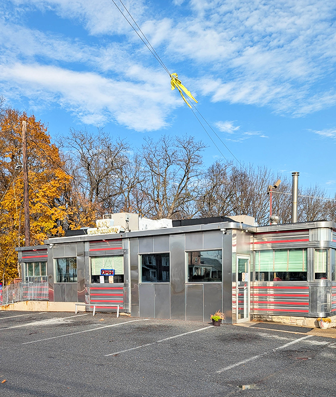 Fall colors frame Route 30 Diner's classic silver exterior – a shining beacon for hungry travelers since before GPS existed.