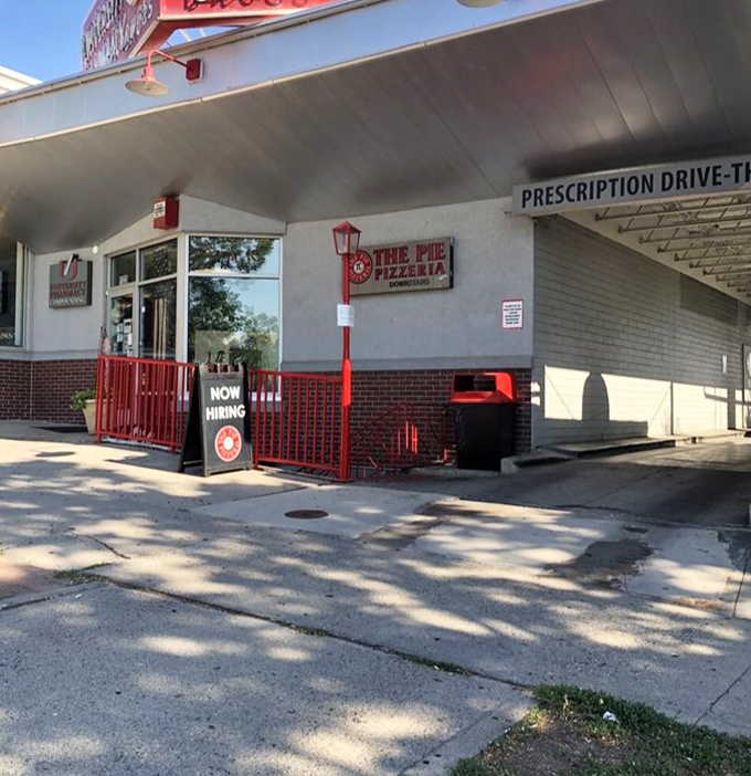 Hidden beneath this unassuming exterior lies a cheese-laden underground paradise. The Pie's entrance is like a portal to pizza nirvana.