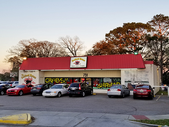Sunset casts a golden glow on The Seafood House, where the colorful "CRABS!" and "SHRIMP!" window art tells you exactly what you're in for.