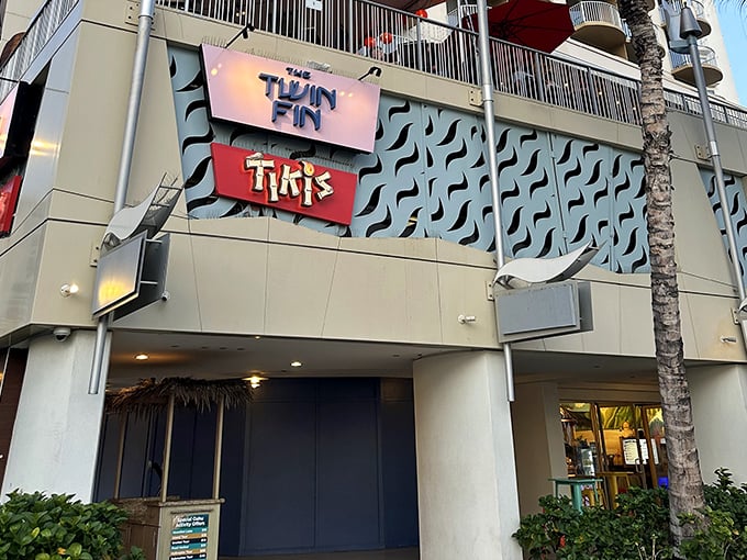 The Twin Fin's crown jewel! Tikis Grill & Bar's vibrant signage promises a flavor explosion that would make Guy Fieri shout "Welcome to Flavortown, Hawaii edition!"