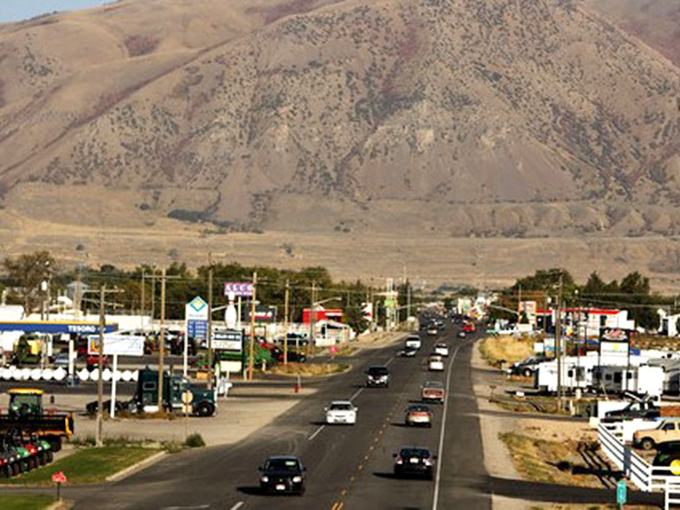 As evening falls on Tremonton, the neon signs glow like beacons of affordable small-town living.