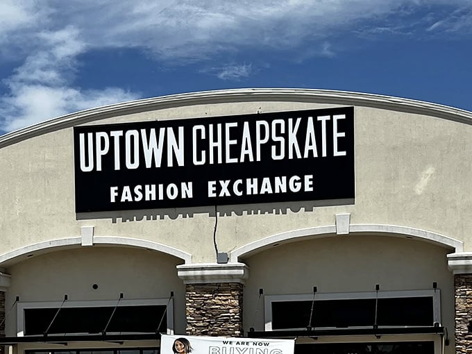 Looking up at thrift store royalty &ndash; Uptown Cheapskate's crown jewel sign against Oklahoma's impossibly blue sky promises fashion redemption below.