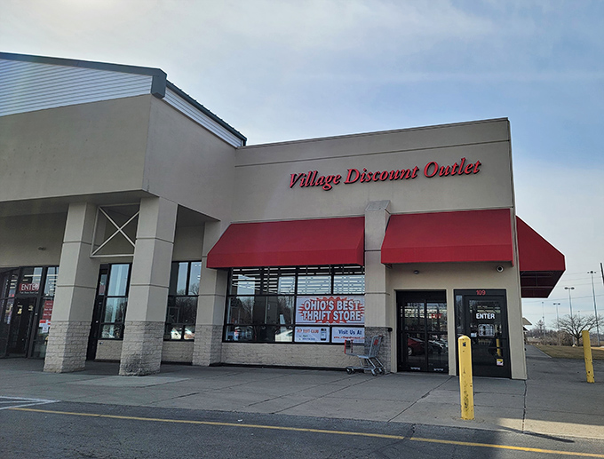 The clean storefront of Village Discount Outlet masks the cheerful chaos within. That entrance is a portal to possibility.