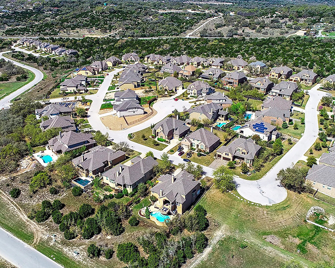 Aerial view of Wimberley shows homes nestled among the trees. When your nearest neighbor is a 100-year-old oak, you know you've found peace.