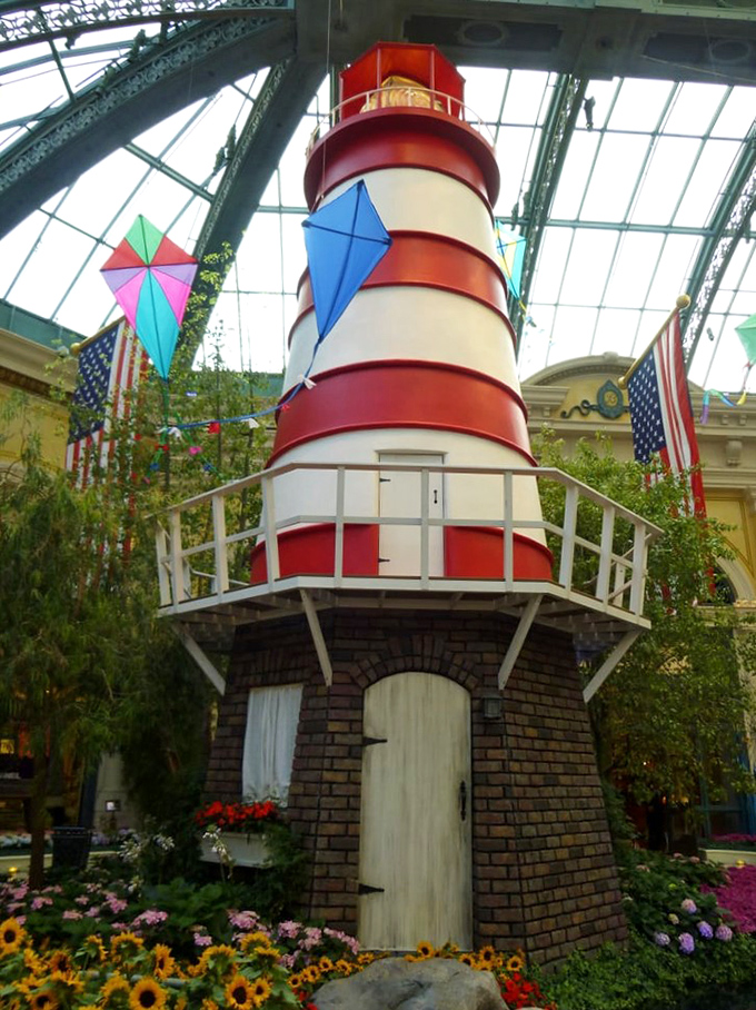 This 32-foot lighthouse stands guard over a summer display, beckoning visitors like moths to a very elaborate flame.