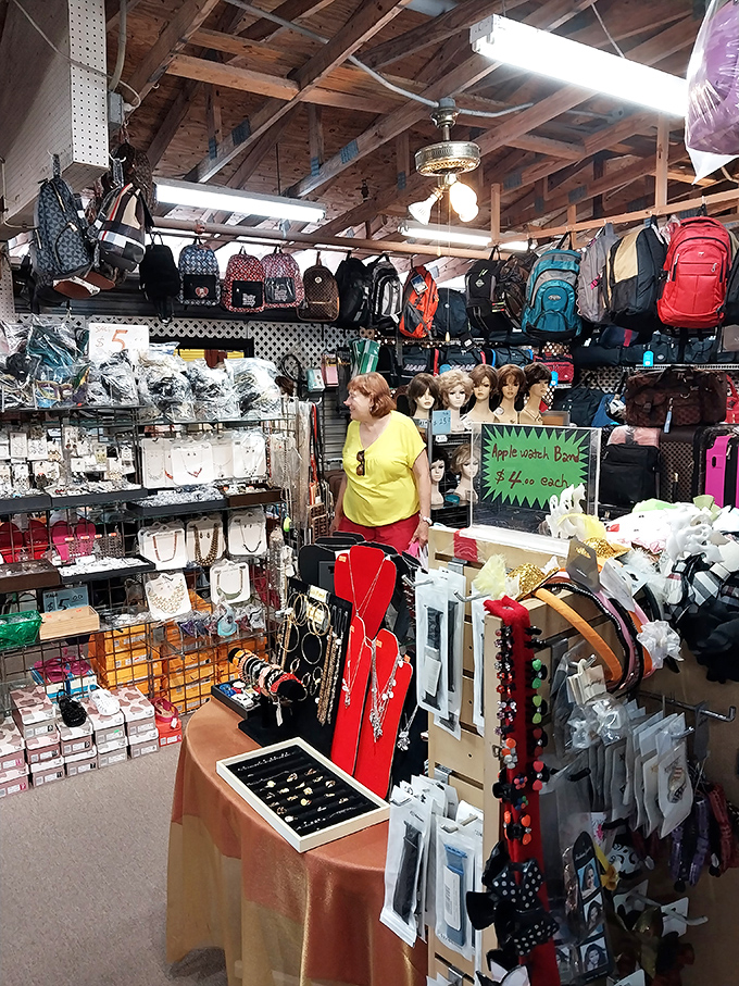 Accessory overload in the best possible way! Handbags, backpacks, and mannequin heads compete for attention in this packed stall of fashion finds.