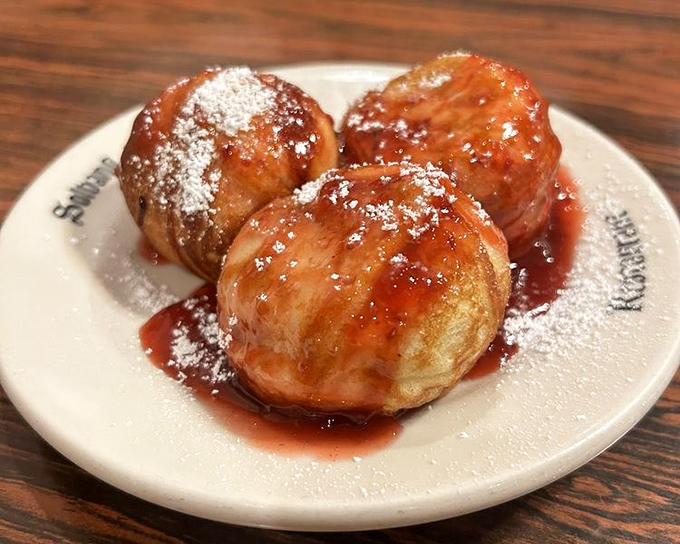 Golden spheres of joy! These aebleskivers with raspberry jam and powdered sugar aren't just pancakes—they're edible proof that the Danes figured out breakfast centuries ago.
