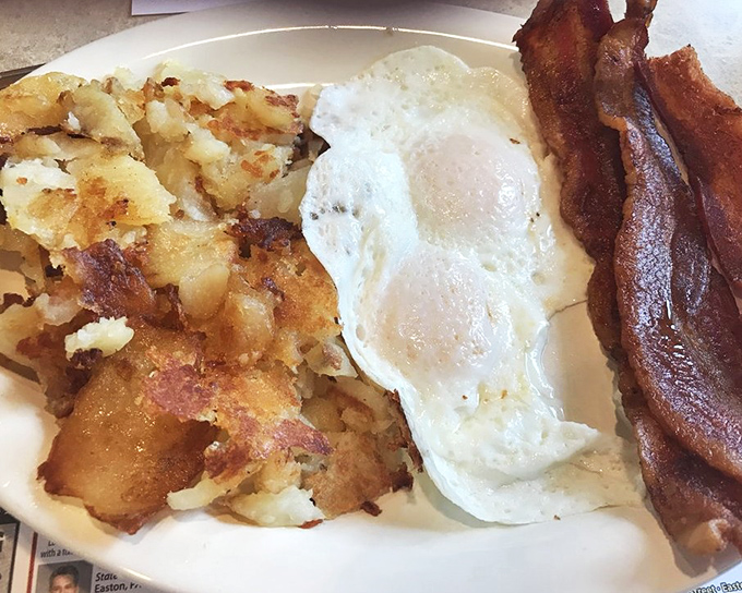 Breakfast perfection in its simplest form: golden homefries with crispy edges, eggs with just-set whites, and bacon that's found that magical sweet spot between chewy and crisp.