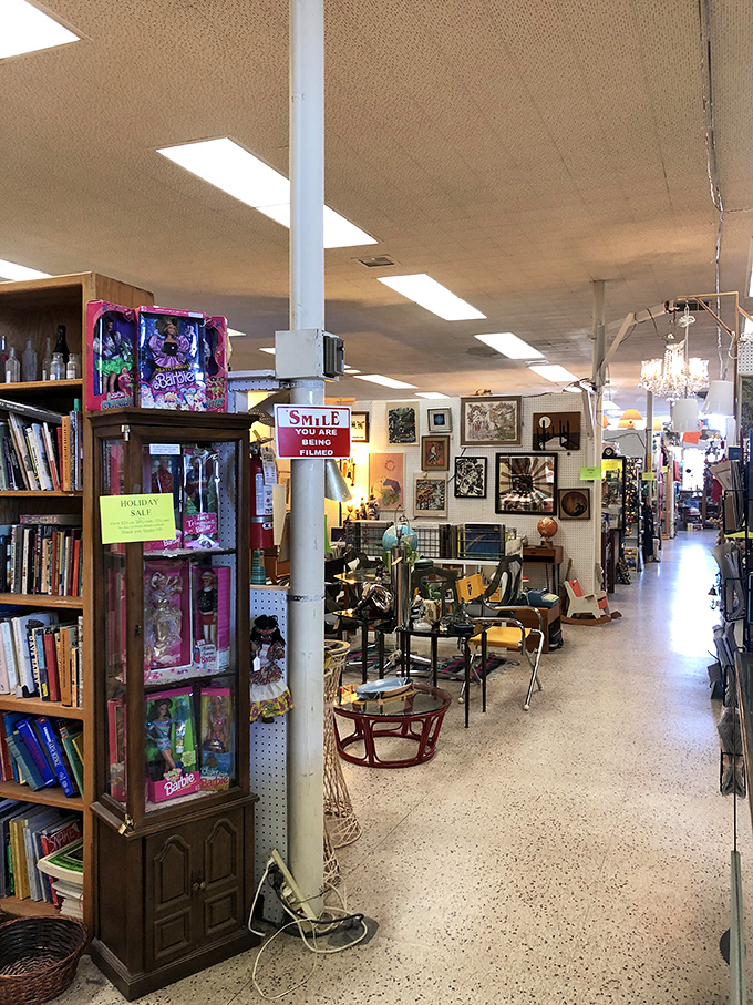 Barbie dolls keeping watch over vintage furniture &ndash; the ultimate timeline of American design stretching down an endless aisle.