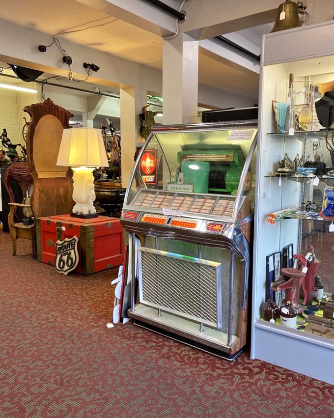 A vintage jukebox stands sentinel beside a Route 66 trunk, each holding memories of road trips and roadside diners from America's golden age.