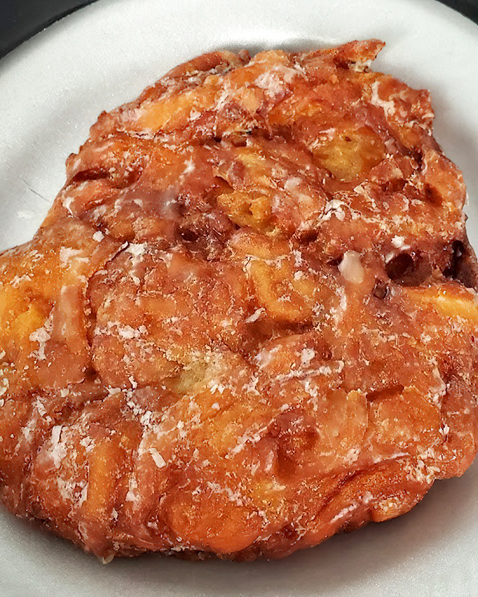 This apple fritter isn't just a donut&mdash;it's a topographical map of flavor country, with peaks of cinnamon and valleys of apple chunks under a glistening glaze.