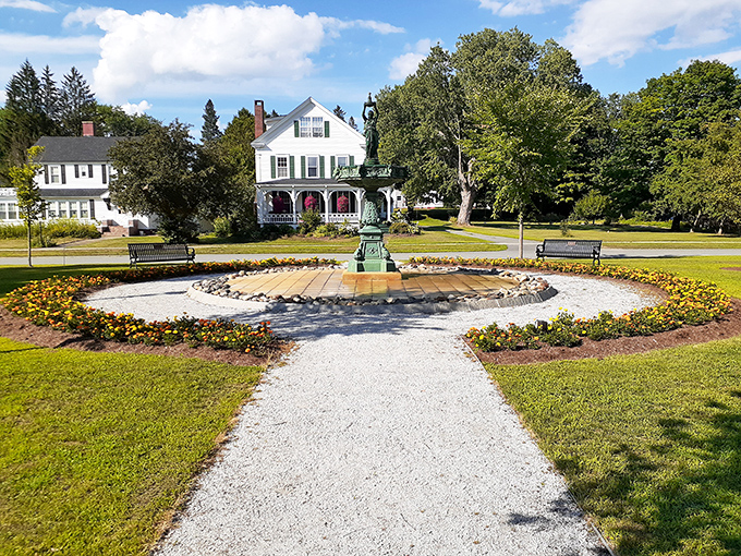 Arnold Park's sunlit garden oasis offers a moment of tranquility, where benches invite contemplation and flowers dance in Vermont breezes.