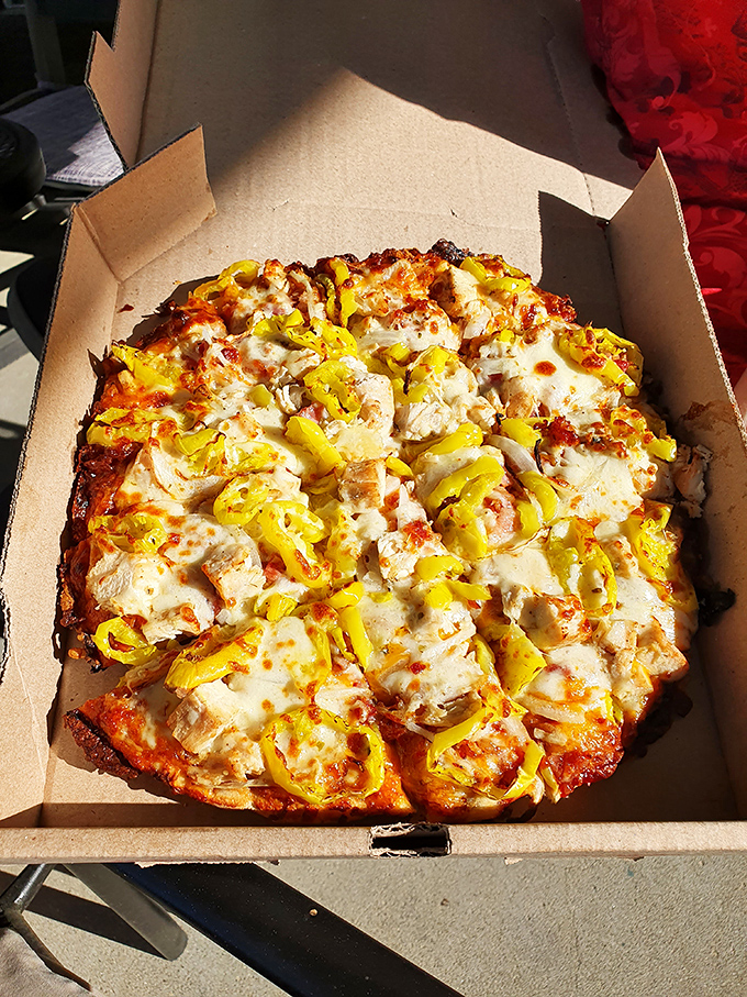 Behold the star of the show! This BBQ Chicken Pizza with its golden crust, tender chicken chunks, and vibrant banana peppers is worth every mile of the journey.