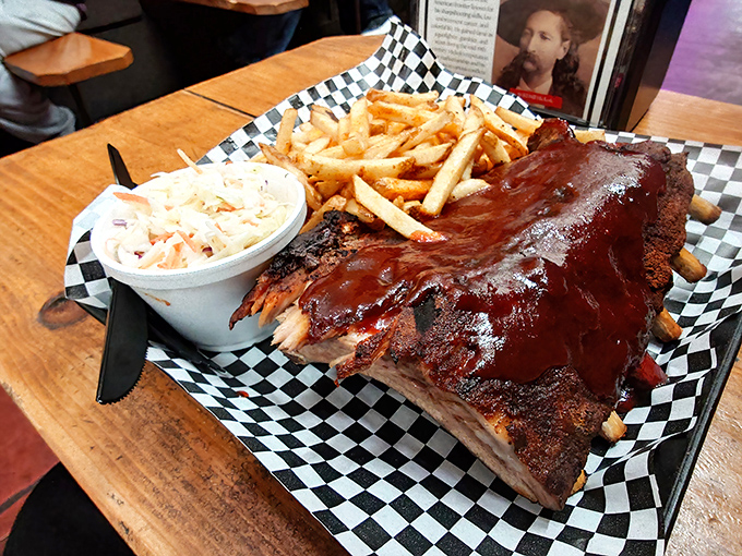 These ribs arrive dressed to impress, glistening like mahogany treasures on checkered paper worthy of a diner hall of fame.