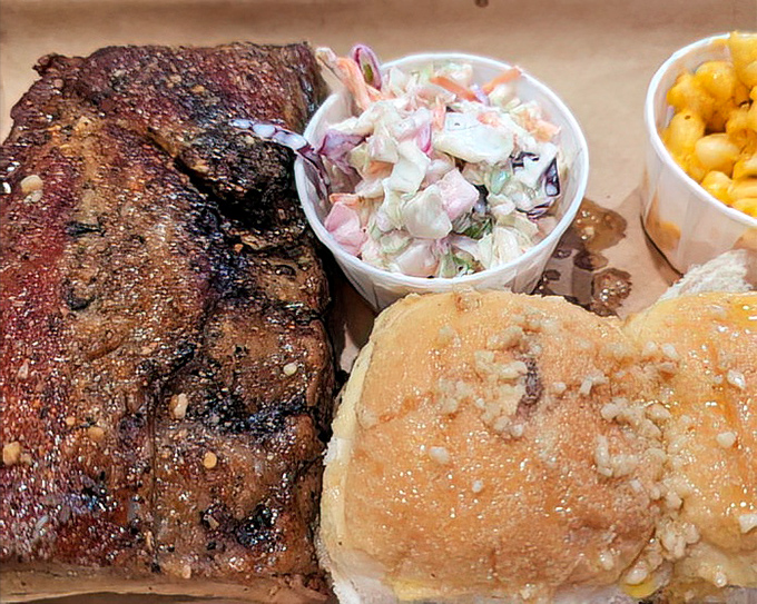 That bark! Those ribs glisten with a perfect spice crust while the coleslaw stands by, ready to cool your palate between bites of smoky perfection.