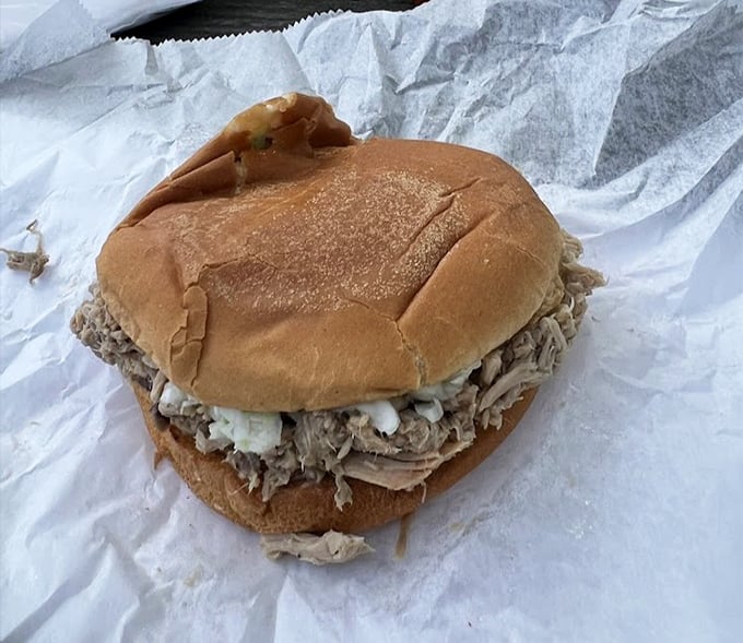 The star of the show: a perfectly simple BBQ sandwich. That soft bun cradling chopped pork is like a warm hug for your taste buds.