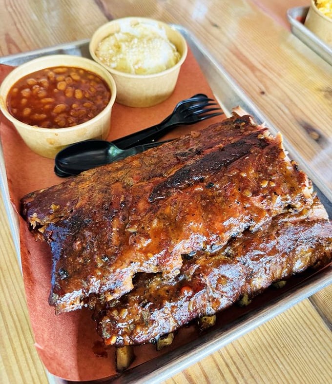 Behold the holy grail of ribs – that mahogany bark, that perfect smoke ring. These aren't falling off the bone; they're clinging to it with dignified deliciousness.