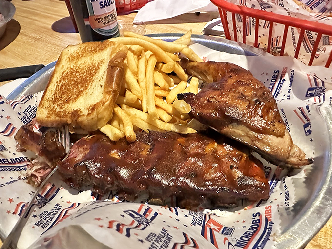 Behold the star of the show&mdash;baby back ribs with a perfect pink smoke ring, flanked by golden fries and buttery toast. This isn't just dinner; it's edible architecture.