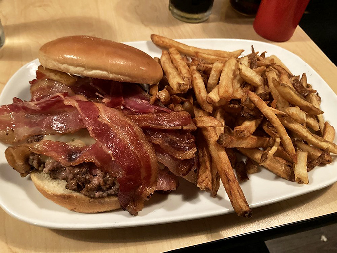 Behold the bacon burger in its natural habitat&mdash;surrounded by golden fries and anticipation. This isn't just lunch; it's an event horizon of flavor.