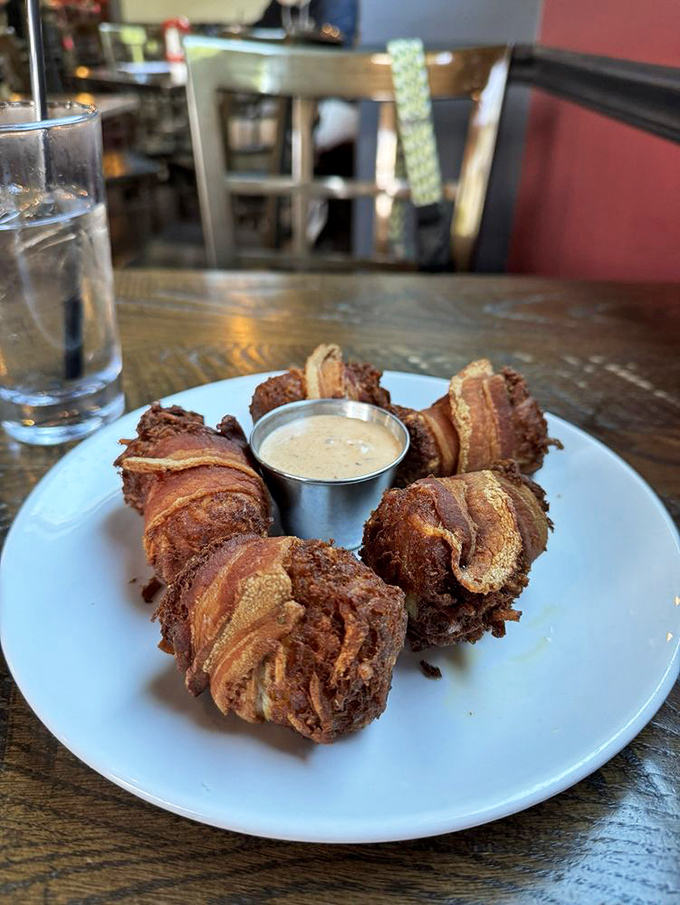 Behold the bacon-wrapped tots in their golden glory! Each crispy bundle is like a tiny gift from the comfort food gods.