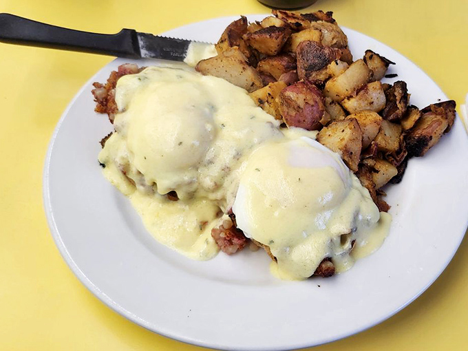 Eggs Benedict done diner-style: perfectly poached eggs draped in hollandaise with a mountain of home fries that could sustain you through winter.