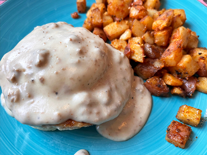 Behold the crown jewel of Aero Diner &ndash; a buttermilk biscuit drowning in peppery sausage gravy, served with home fries that could make a potato farmer weep with pride.