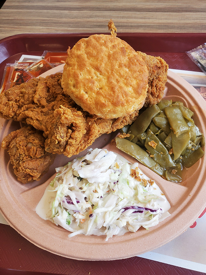 Southern perfection on a plate: golden-fried chicken, a buttery biscuit, and sides that would make your grandmother nod in silent approval.