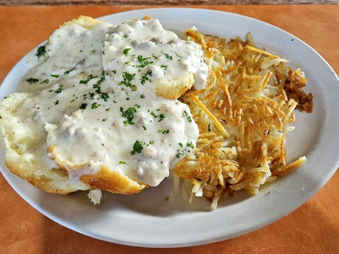 Biscuits and gravy so good they should require a permission slip. Crispy hash browns standing guard, ensuring no plate space goes unfilled.