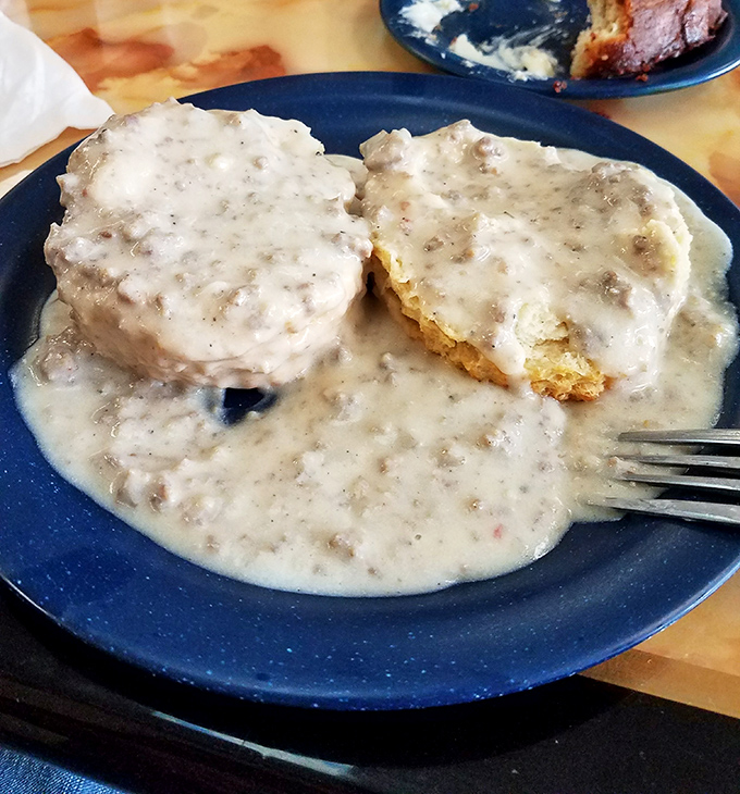 Biscuits swimming in creamy sausage gravy&mdash;a Southern baptism for your taste buds. This plate doesn't just speak comfort food; it sings a full gospel choir of it.