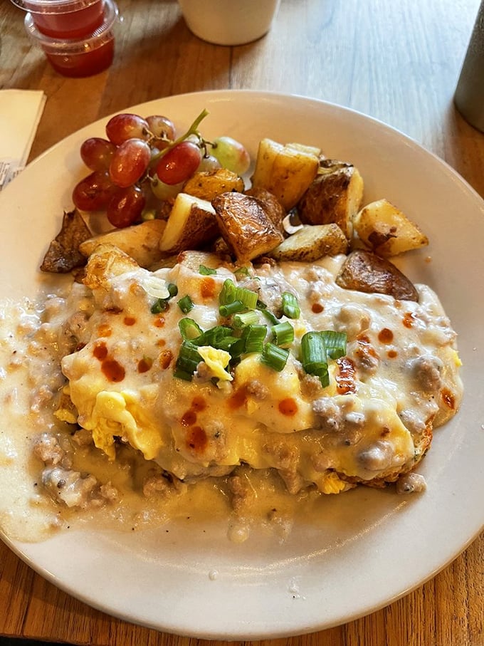Behold the holy grail of breakfast: creamy sausage gravy cascading over golden eggs with perfectly roasted potatoes standing guard. Napkins required.