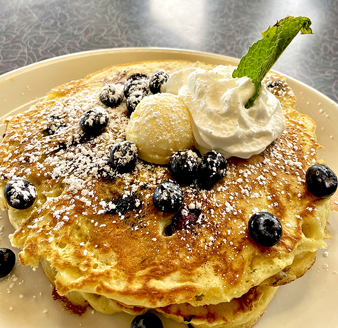 These blueberry pancakes aren't just breakfast&mdash;they're an edible work of art. That dollop of whipped cream is the chef's signature.