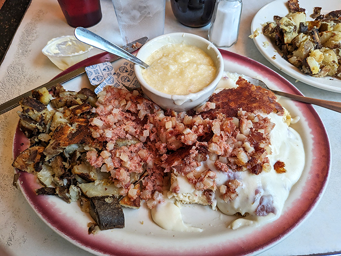 Behold the holy trinity: crispy scrapple, creamy grits, and eggs that actually know their job description.