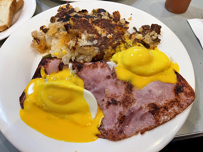 Eggs Benedict with ham isn't just breakfast—it's performance art. That hollandaise sauce practically deserves its own Broadway show.