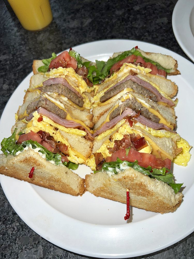 This club sandwich isn't just stacked – it's architected with the precision of a Frank Lloyd Wright design, but with significantly more bacon.