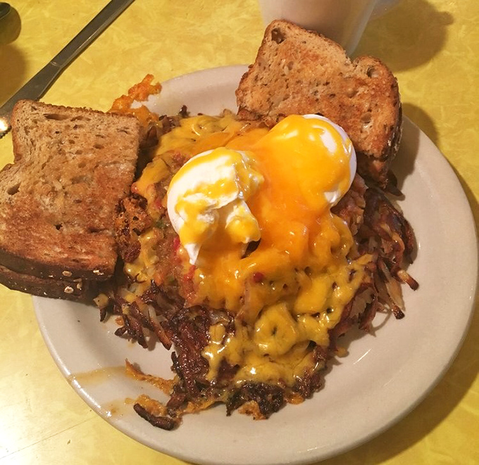 Hash browns crisped to golden perfection, topped with melted cheese and poached eggs&mdash;this is what breakfast dreams are made of.