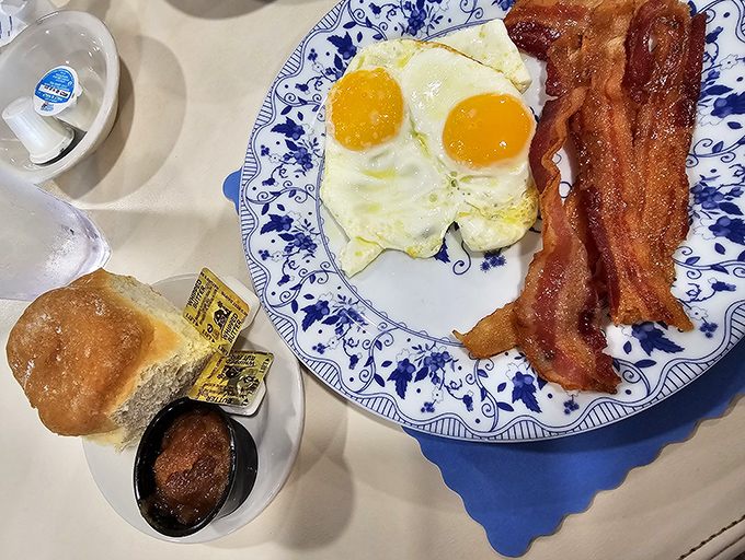 Sunny-side perfection meets crispy bacon on blue willow china&mdash;breakfast as it was meant to be experienced.