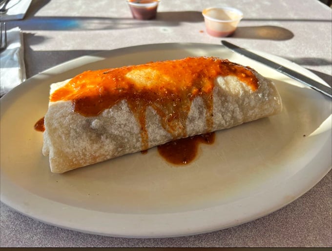 This breakfast burrito isn't just wrapped in a tortilla&mdash;it's cloaked in possibility, smothered in that legendary orange-hued chile that haunts Denver dreams.