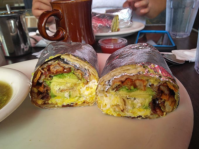 Breakfast burritos so stuffed they need aluminum foil reinforcement. The avocado-egg-potato ratio here is what mathematicians call "the golden equation."