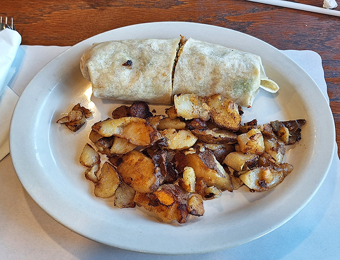 The legendary breakfast burrito in its natural habitat. This flour-wrapped wonder is what morning dreams are made of, served with a side of golden homefries.