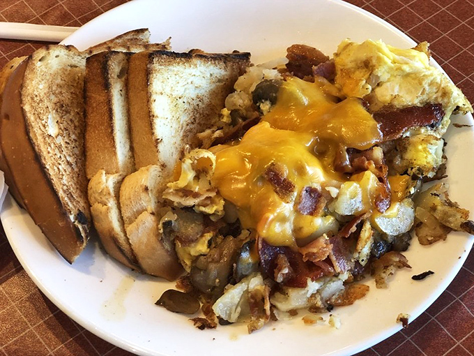 Breakfast alchemy at its finest! This mountain of cheesy potato scramble and toast could fuel a lumberjack convention or one very determined retiree.