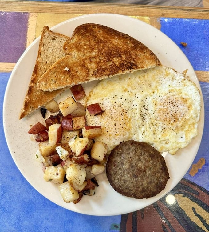 Breakfast trinity: perfectly cooked eggs, seasoned home fries with a hint of rosemary, and toast that's actually worth eating. Hallelujah! 