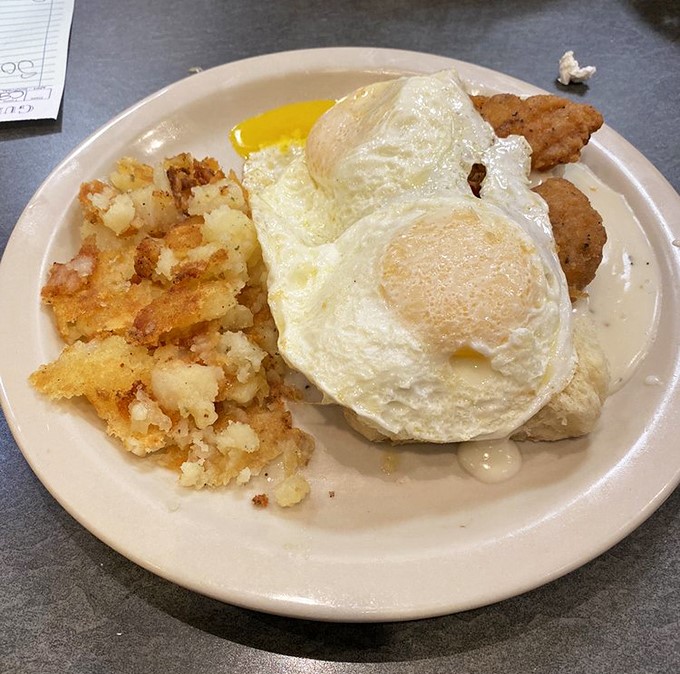 Sunny-side up eggs with that perfect runny yolk, crispy home fries, and chicken&mdash;the breakfast trinity that makes mornings worth facing.