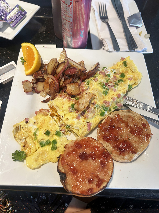 Breakfast architecture at its finest&mdash;a perfectly folded omelet alongside crispy home fries and English muffins that have achieved that elusive golden-brown perfection.