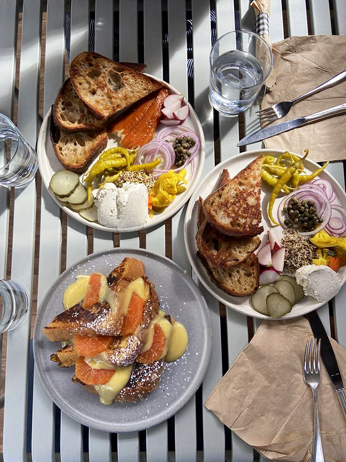 Breakfast alchemy: toasted bread, smoked salmon, pickled vegetables, and soft cheese create a morning symphony that Mozart would have ordered seconds of.