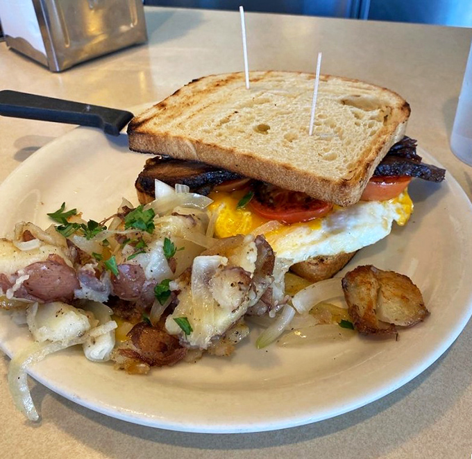 Breakfast sandwich architecture at its finest&mdash;a perfect egg, crispy bacon, and griddled bread with house potatoes that deserve their own fan club.