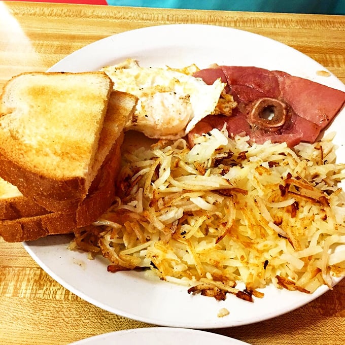 Breakfast perfection: Crispy hash browns with the ideal golden-to-potato ratio alongside eggs and ham that mean business.