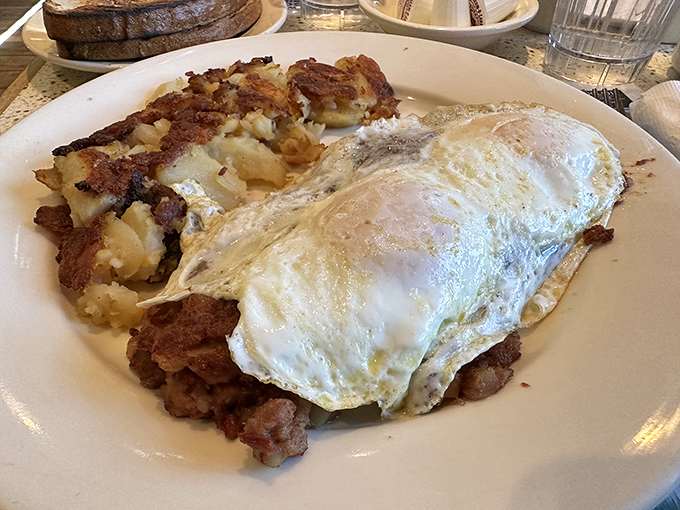 Breakfast nirvana achieved: perfectly cooked eggs lounging beside home fries with just the right crisp-to-fluffy ratio. This plate doesn't need Instagram filters.