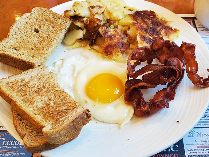 Breakfast perfection on a plate &ndash; where the sunny-side-up egg is actually smiling at you and the bacon has achieved ideal crispiness.