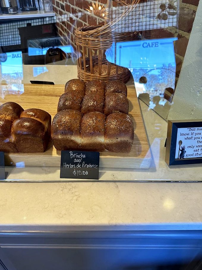 Golden brioche loaves stand at attention like delicious soldiers. The herbs de Provence sprinkled on top are the French countryside in edible form.